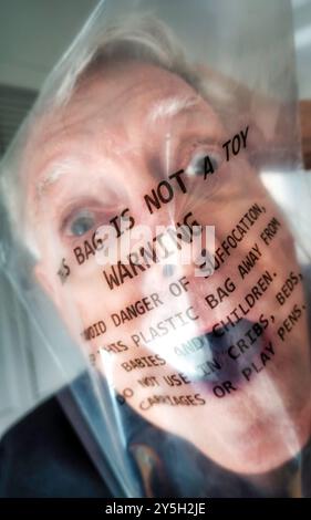 A Mature man with suffocating with transparent plastic bag flying over ...
