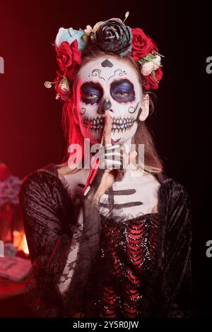 Mysterious woman doing shush finger gesture during Day of the Dead ...