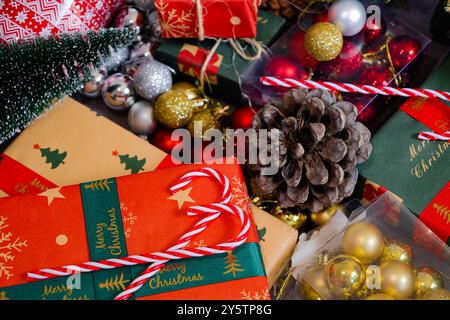 Glass with Christmas balls and candy canes on wooden background with ...