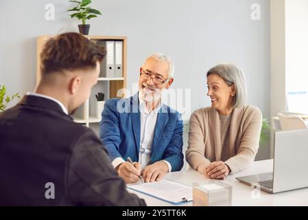 Advisor meeting with happy senior couple discussing investment and ...