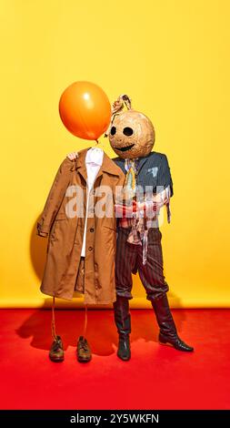 Person in creepy ripped costume and mask, standing next to mannequin ...