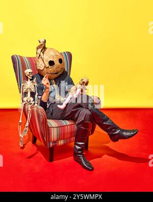 Terrifying character in ripped clothes and creepy mask, standing with ...