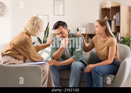 Upset young man with his wife visiting psychologist in office Stock ...
