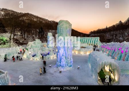 Visitors exploring huge frozen ice sculptures on the shore of Lake ...