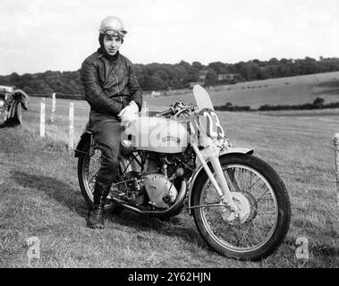 John Surtees sitting astride his racing MV Augusta motorbike inside his ...