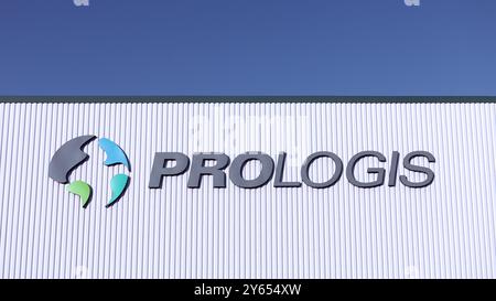 Prologis logo on outdoor sign tower against blue sky with office buildings in background, San ...