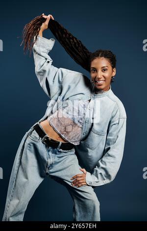 A fit woman strikes a confident pose in the gym after an intense workout, showcasing her ...