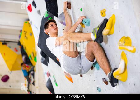 Man training at bouldering gym without special climbing equipment Stock ...