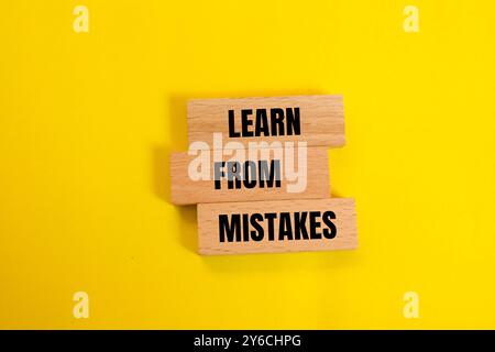 Learn from mistakes message written on ripped torn yellow paper with ...