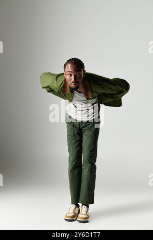 Confident Young Man Posing Against a Gray Background in Casual Attire ...