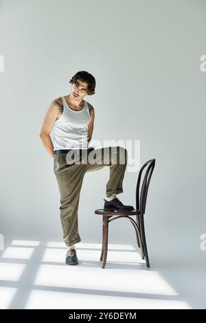 Young man resting on grey couch in living room Stock Photo - Alamy