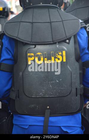 Indonessian Police wearing black anti-riot safety vests Stock Photo - Alamy