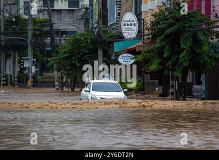 A car seen driving along a flooded street in the Chang Khlan area due ...