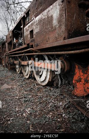 Old forgotten train on the tracks. A rusty and damaged freight railway ...