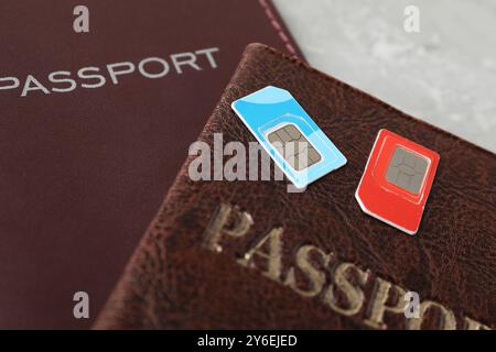 Passports and SIM cards on grey table, closeup Stock Photo - Alamy
