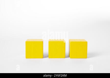 Many yellow wooden cubes isolated on white Stock Photo - Alamy