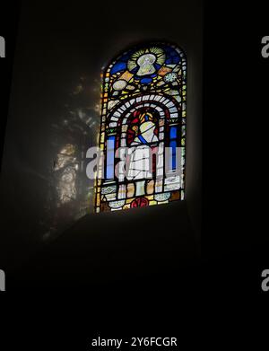 A stained glass window in the twelfth century christian church of St ...