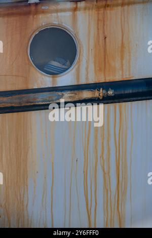 Porthole on the side of a rusty boat Stock Photo - Alamy