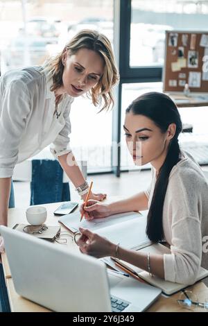 Working through some concepts. Two young colleagues conducting a ...