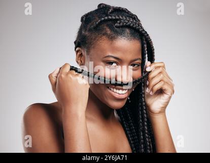 Cheerful black girl with cool braids having fun in the city. She is ...