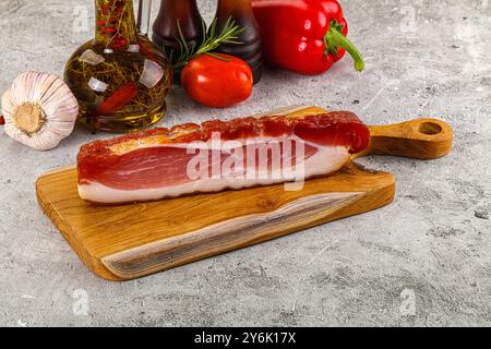 Piece prosciutto crudo meat over board Stock Photo - Alamy