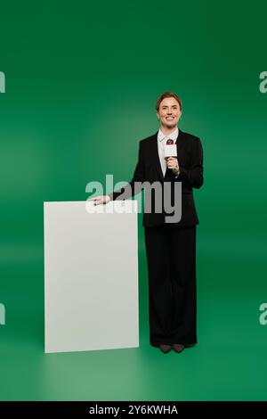 A poised TV presenter in elegant black attire communicates with viewers ...