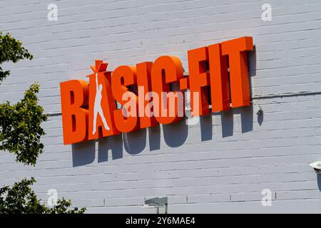 Orange Basic-Fit logo sign at the gym. Basic Fit is the largest fitness ...