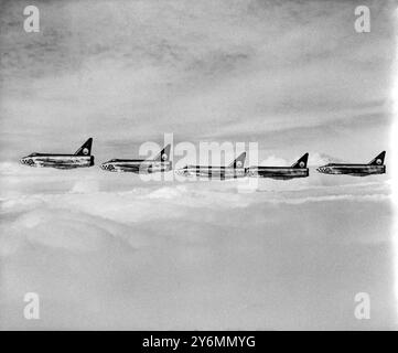 Group of supersonic planes in formation flying in the sky in a military ...
