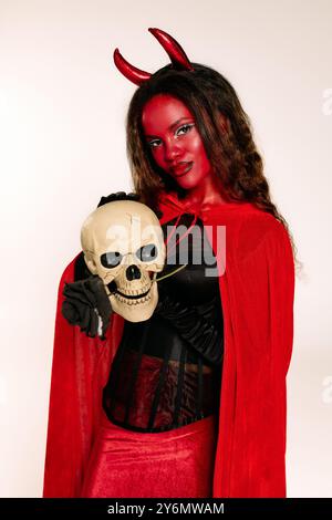 A captivating woman dressed as a devil showcases her bold Halloween ...