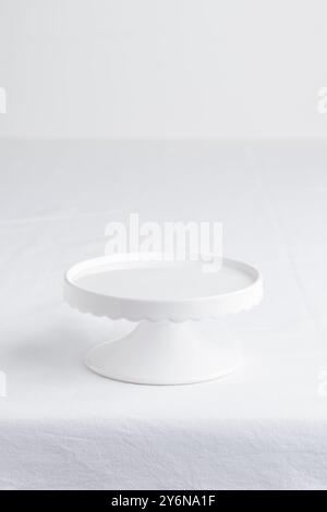 Empty tableware - white cakestand with a clear glass on white ...