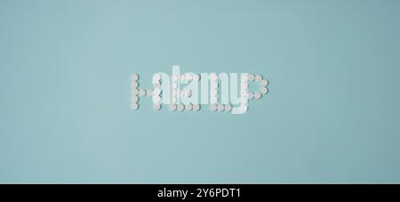 Help lettering made with white round pills, pharmaceutical medicament ...