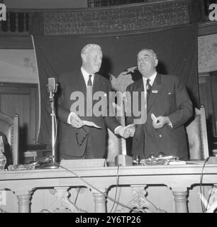 Sir Stanley Rous, President of FIFA, poses in London with a replica of ...