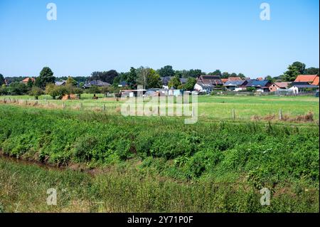 Green meadow and house backyards at the Flemish countryside in Halen ...