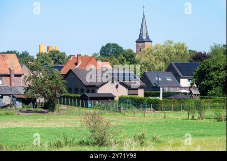 Green meadow, house backyards and church tower at the Flemish ...