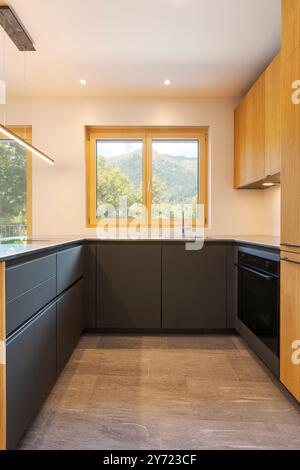 Sink in front of kitchen window with view of garden Stock Photo - Alamy