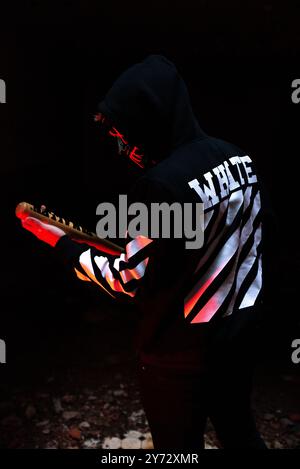 A creepy masked character of the purge anarchy with a baseball bat ...