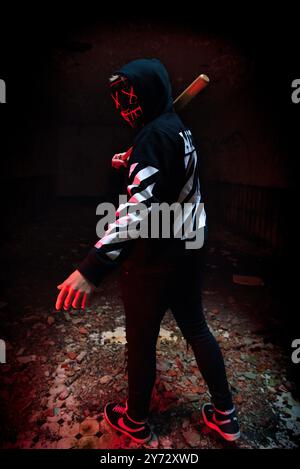 A creepy masked character of the purge anarchy with a baseball bat ...