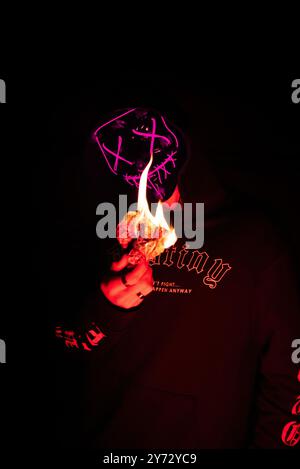 A creepy masked character of the purge anarchy with a baseball bat ...