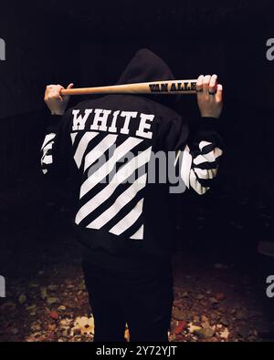A creepy masked character of the purge anarchy with a baseball bat ...