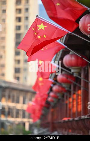 National flags of China are hung in the street light, welcoming the ...