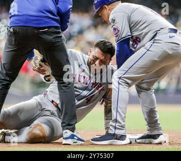 New York Mets third base coach Mike Sarbaugh (88) stands on the field ...