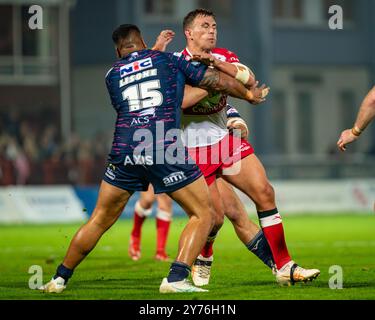 Sam Lisone of Leeds Rhinos is tackled during the Betfred Super League ...