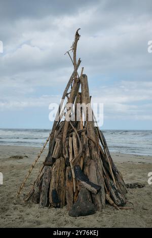 Driftwood teepee structure on Mendihuaca beach, Colombia Stock Photo ...