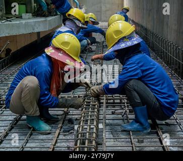 A group of builders is busy constructing a metal structure Stock Photo ...