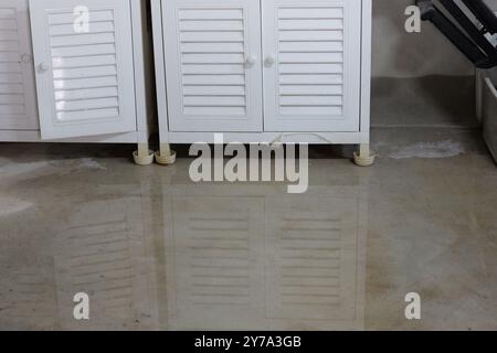 Water spreading. flooding on storage room concrete floor in a house ...