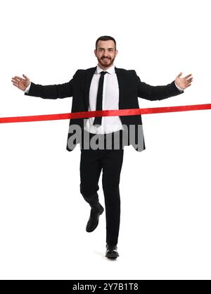 Businessman in suit crossing red finish line on white background Stock ...
