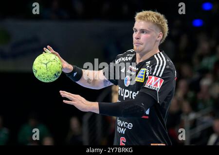 Marek Nissen (HC Erlangen, #06) during the throw around Stephan Seitz ...