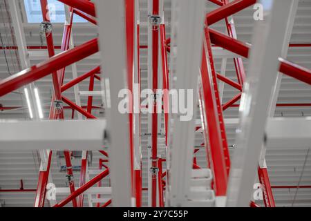 Close up photograph of sprinkler system head inside warehouse racking ...