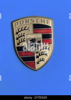 Historic old Porsche crest logo on red painted bonnet of vintage ...