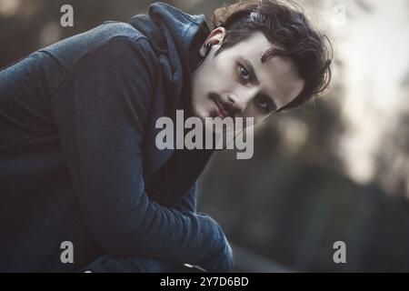 Photo portrait man in earphones talking in support service pointing up ...